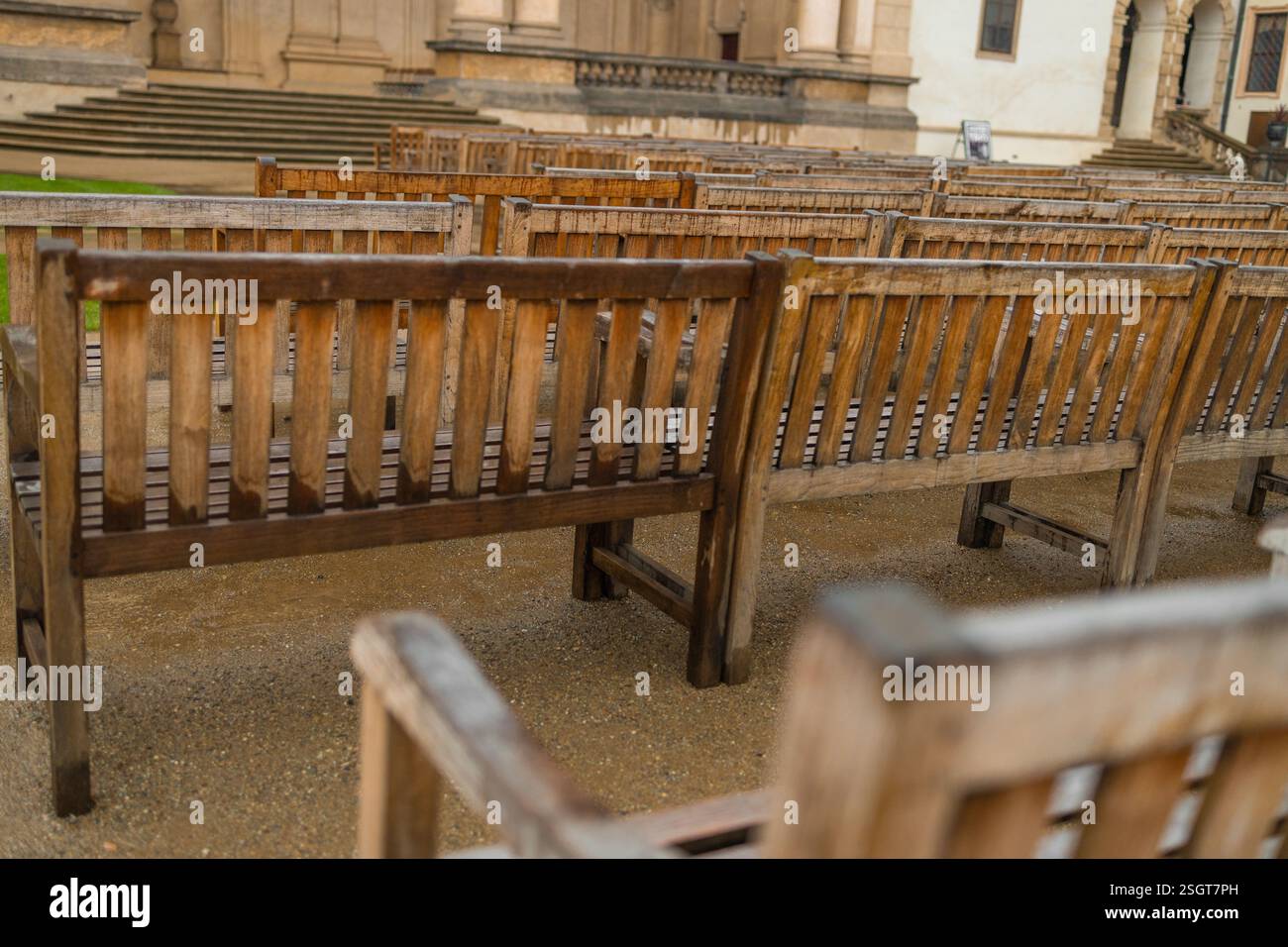 A modern wooden benches standing in the park. Comfortable bench in recreation area. City ...