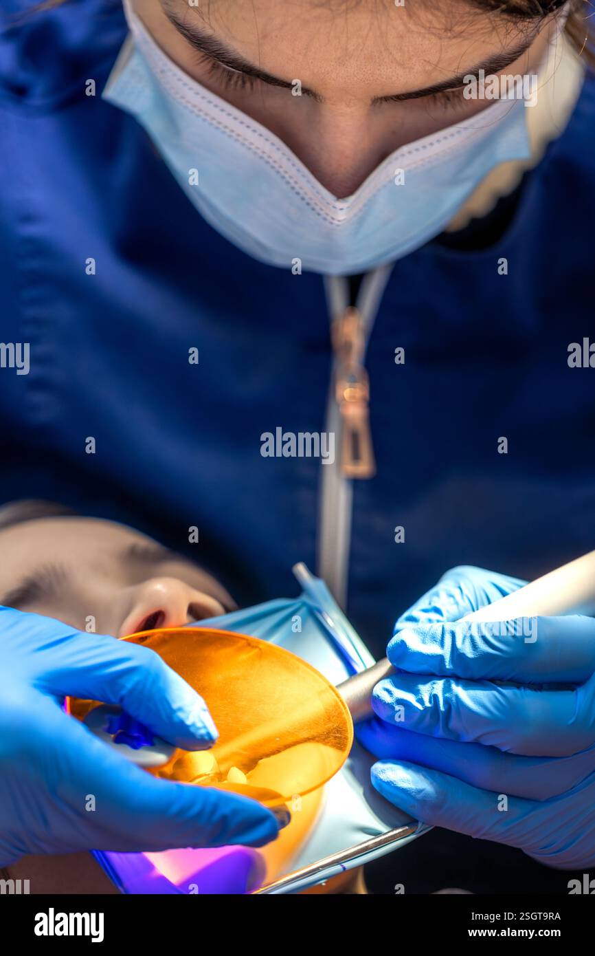 Dental fillings. Dental fillings with ultraviolet light. Female dentist ...