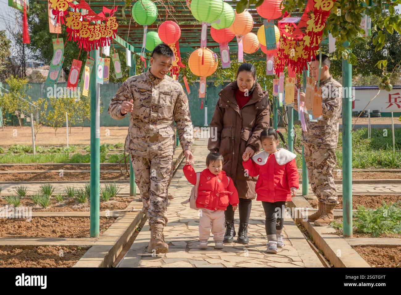 Soldiers and family members participate in a lantern riddle-guessing ...