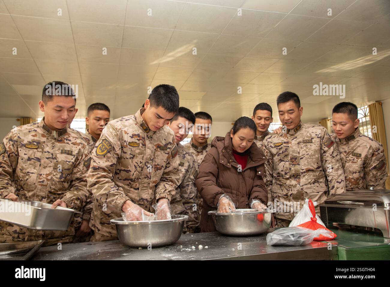 Soldiers and military wives gather to wrap yuanxiao to celebrate the ...