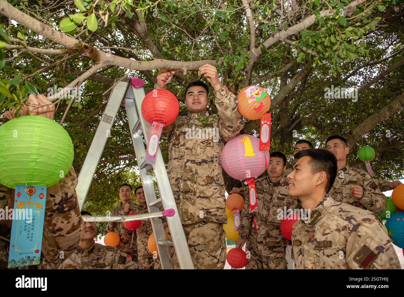 Soldiers arrange lanterns to celebrate the upcoming Lantern Festival in ...