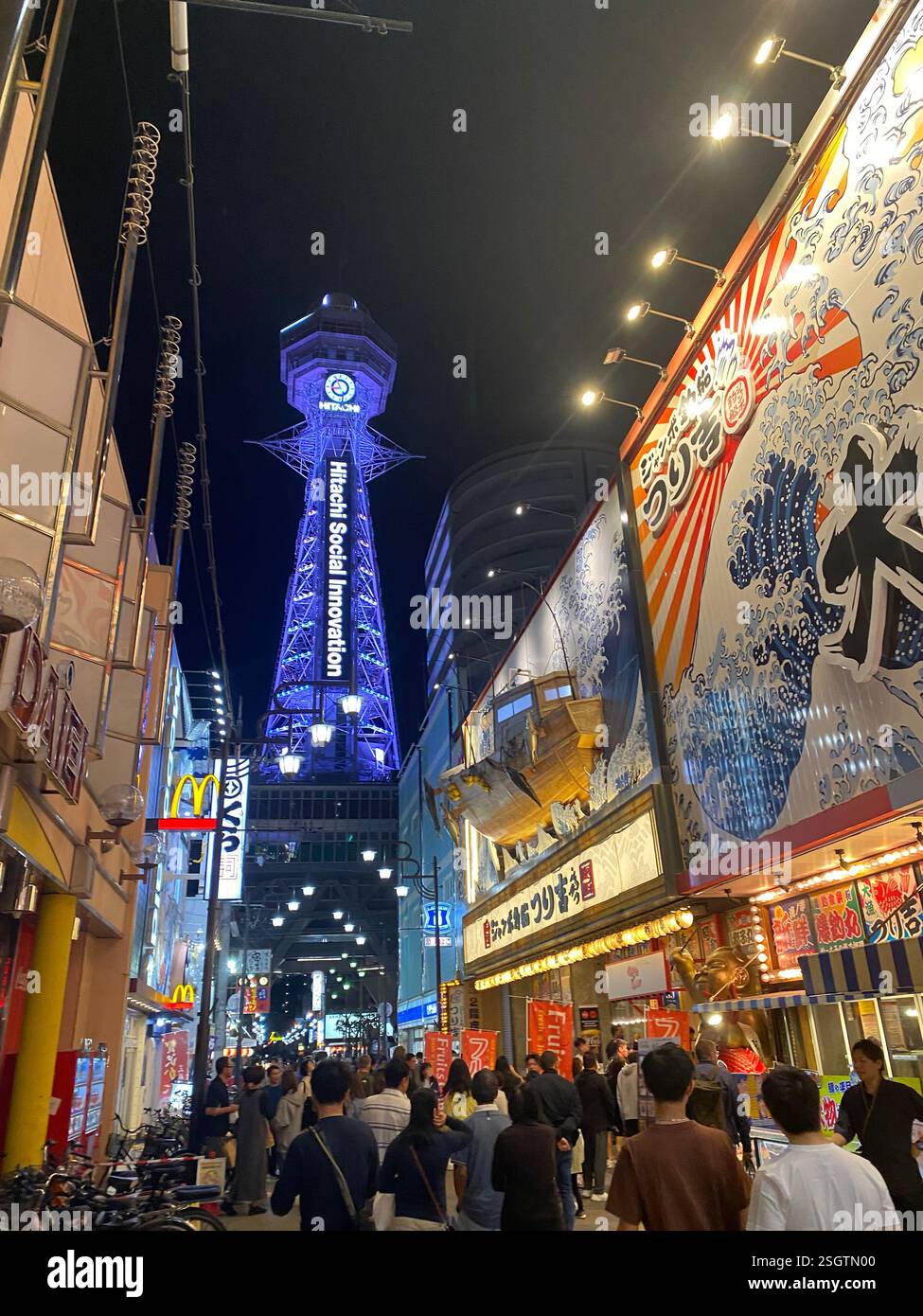 The vibrant and colorful area of the Tsutenkaku tower in Osaka is a ...
