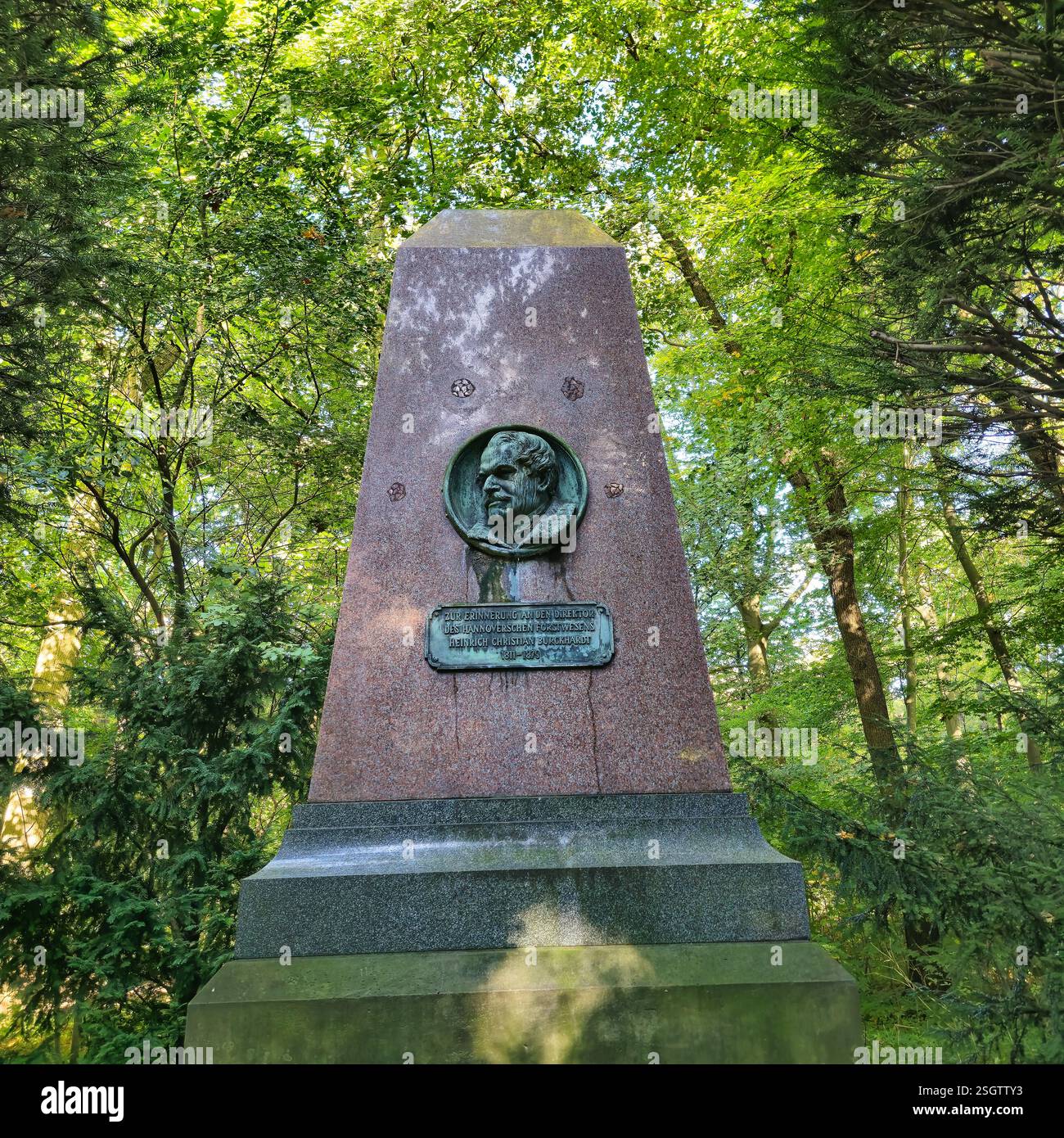 This is a striking and captivating monument featuring a detailed bust ...