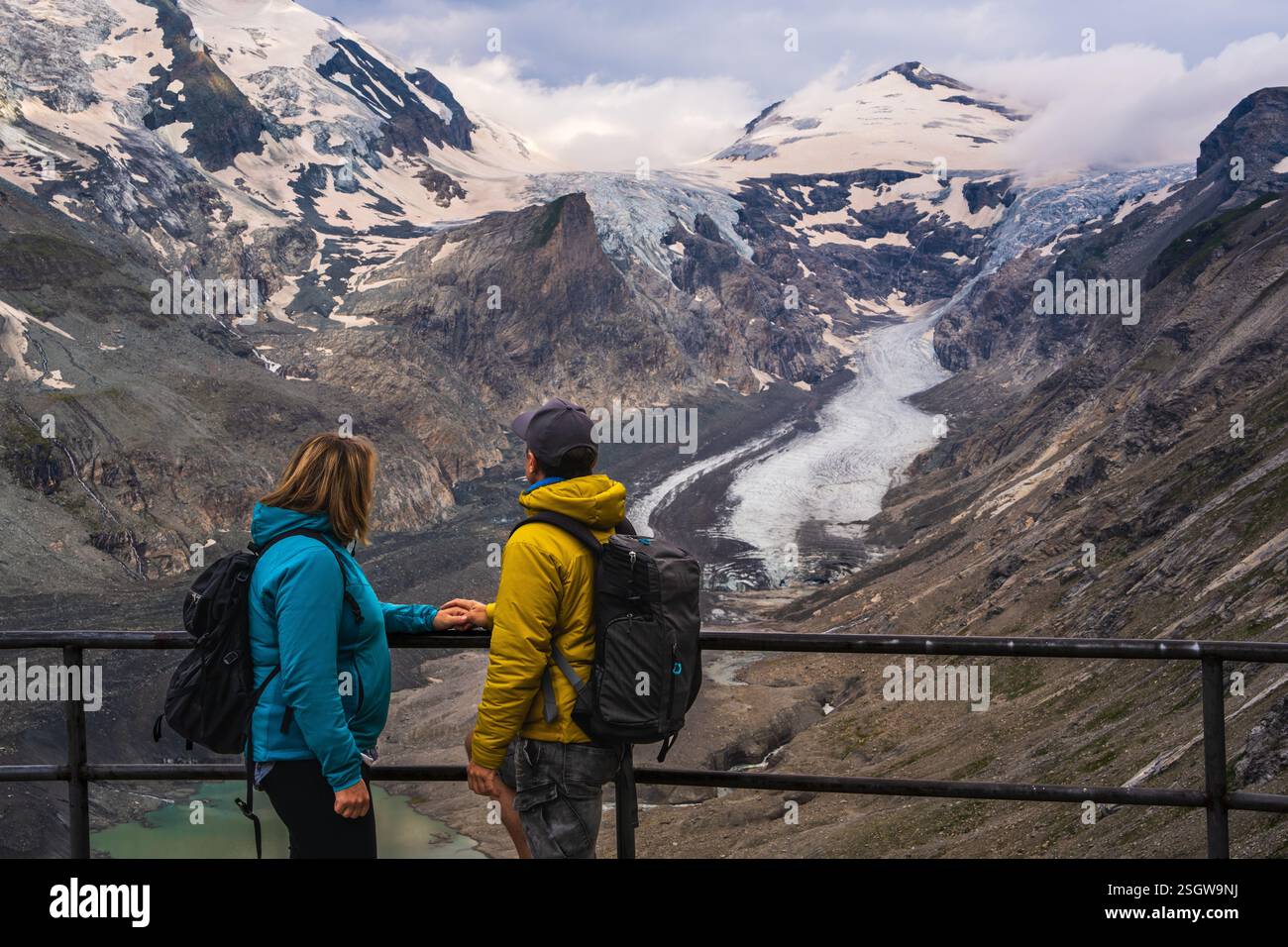 Middle aged man and woman stand on viewing platform overlooking ...