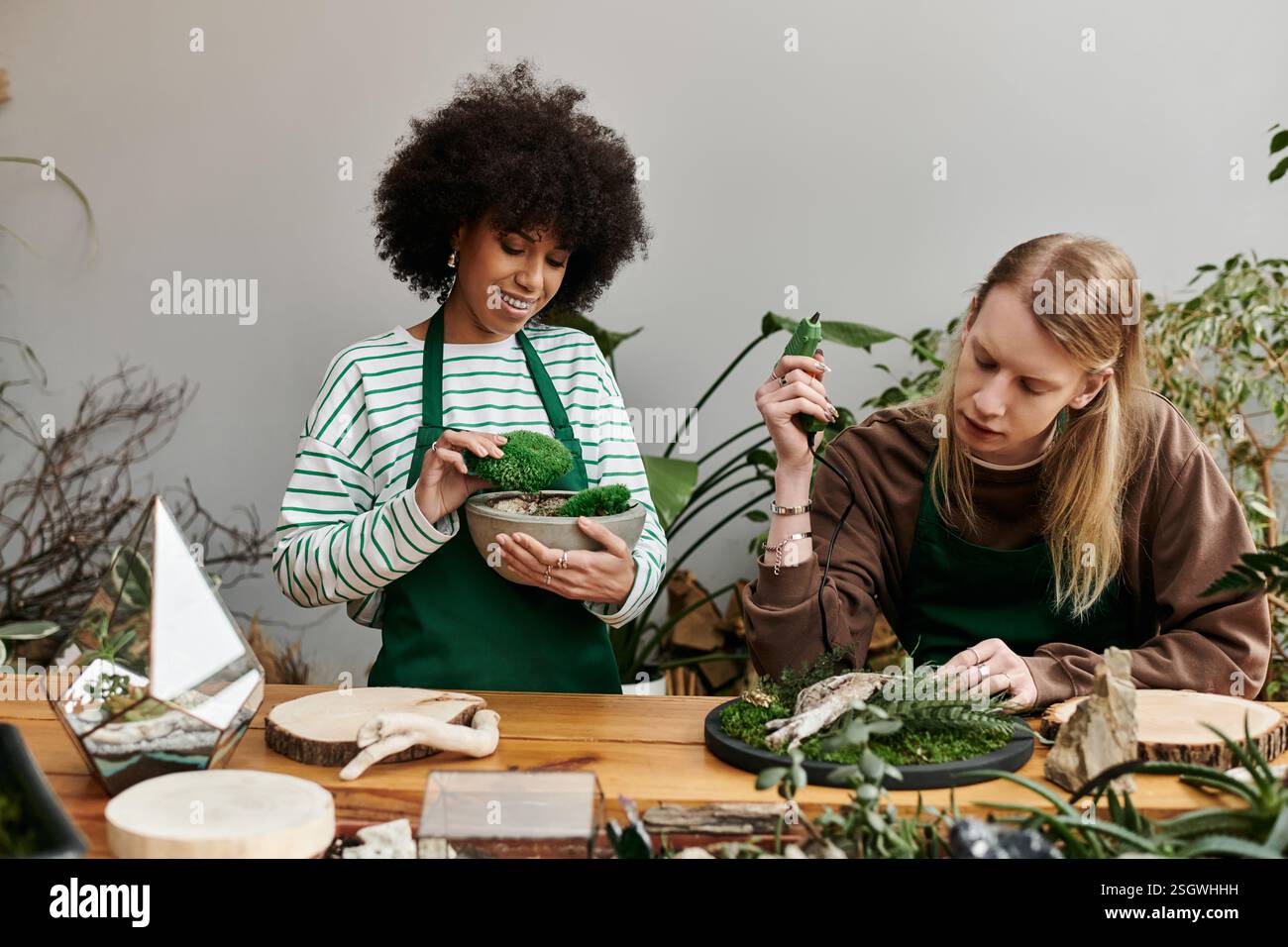 Two friends enjoy crafting succulent arrangements in a cheerful ...