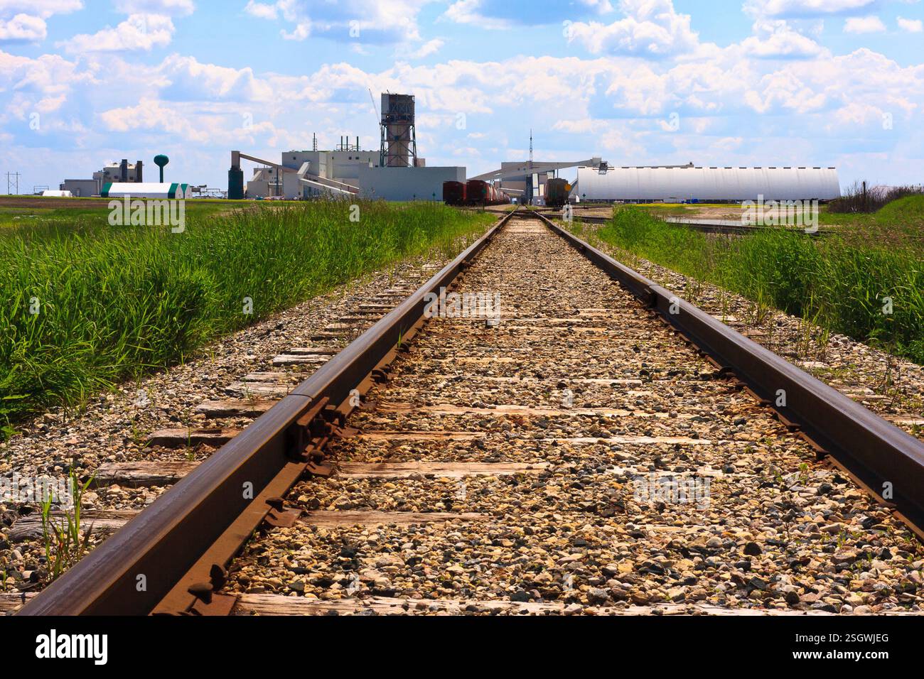 Train track with a train in the distance. The train is on the right ...