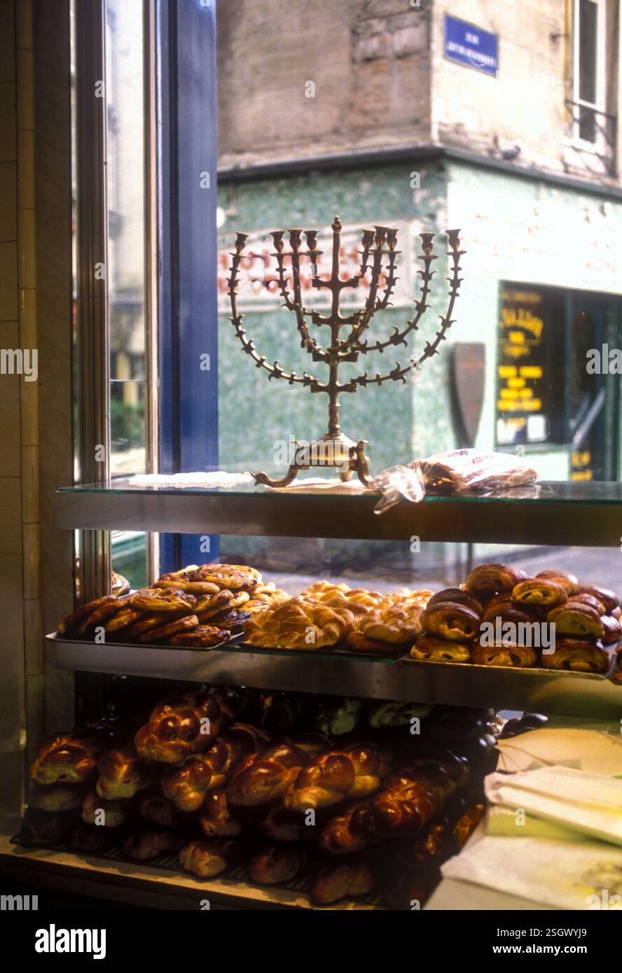 French, Jewish bakery displaying a menorah, pastries and loaves of ...