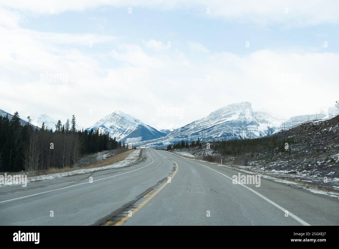 Driving on empty road in Alberta, Canada with Canadian Rockies in ...