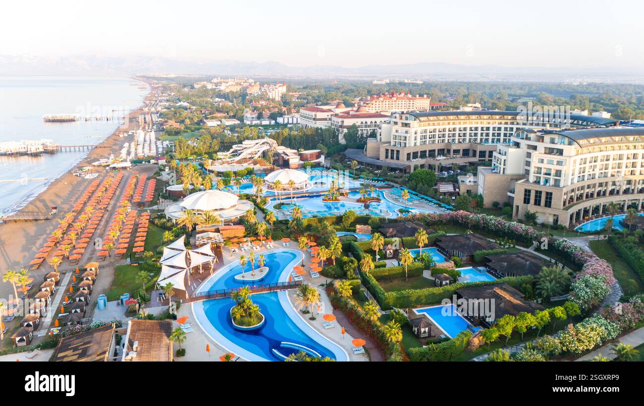 Aerial view of a beachfront luxury resort with a water park, pools, and ...