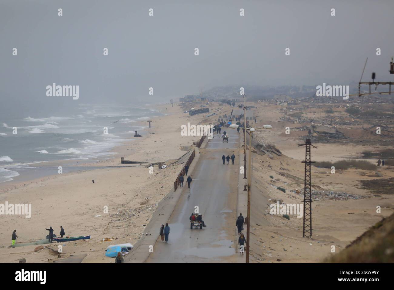 People walk along al-Rashid street between Gaza City and Nuseirat in ...