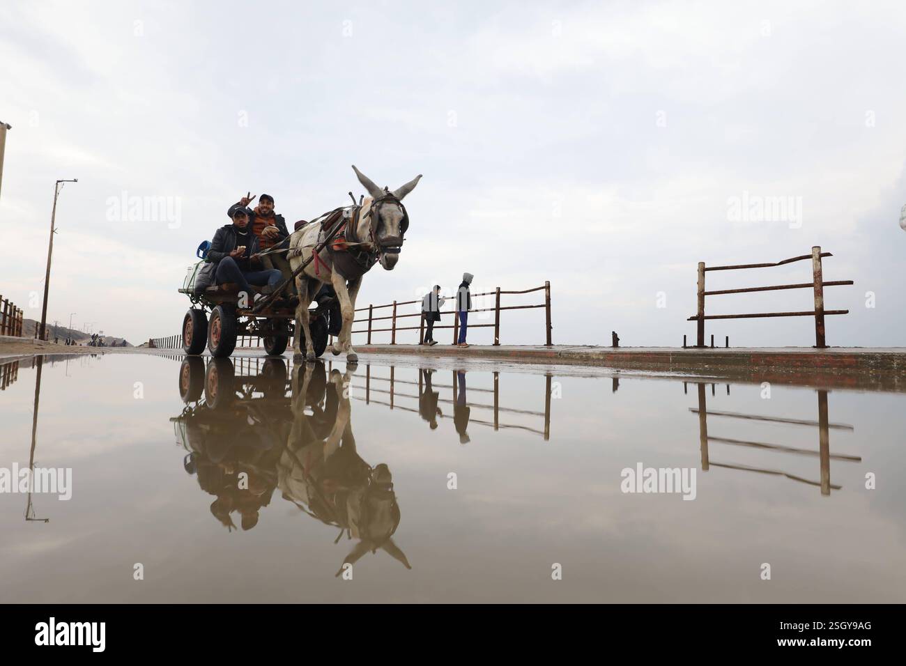 People walk along al-Rashid street between Gaza City and Nuseirat in ...
