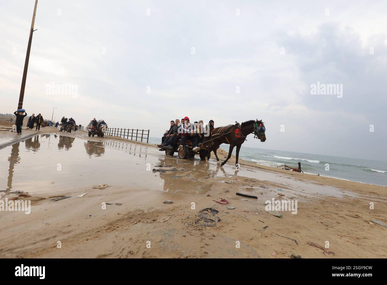 People walk along al-Rashid street between Gaza City and Nuseirat in ...