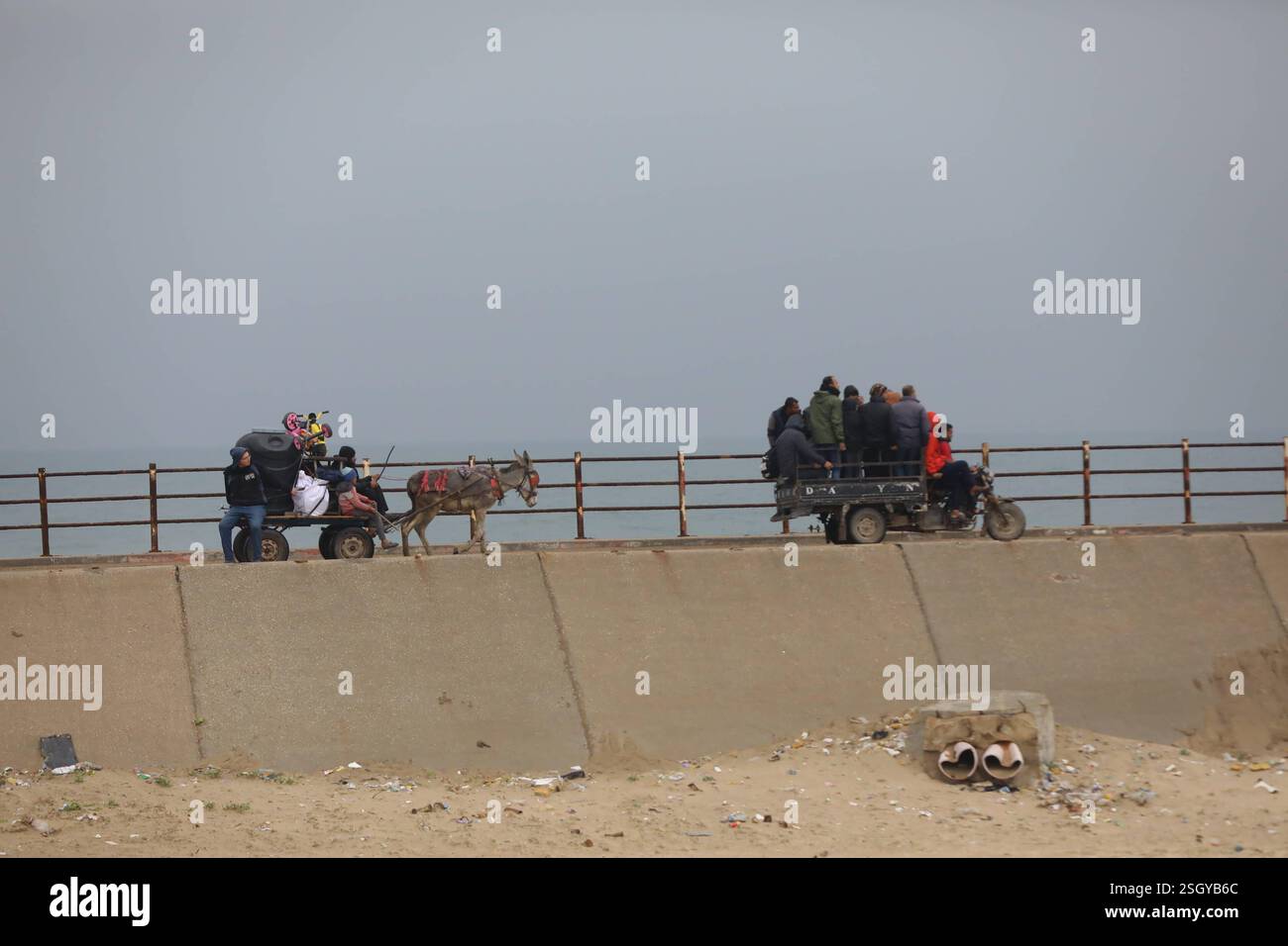 People walk along al-Rashid street between Gaza City and Nuseirat in ...