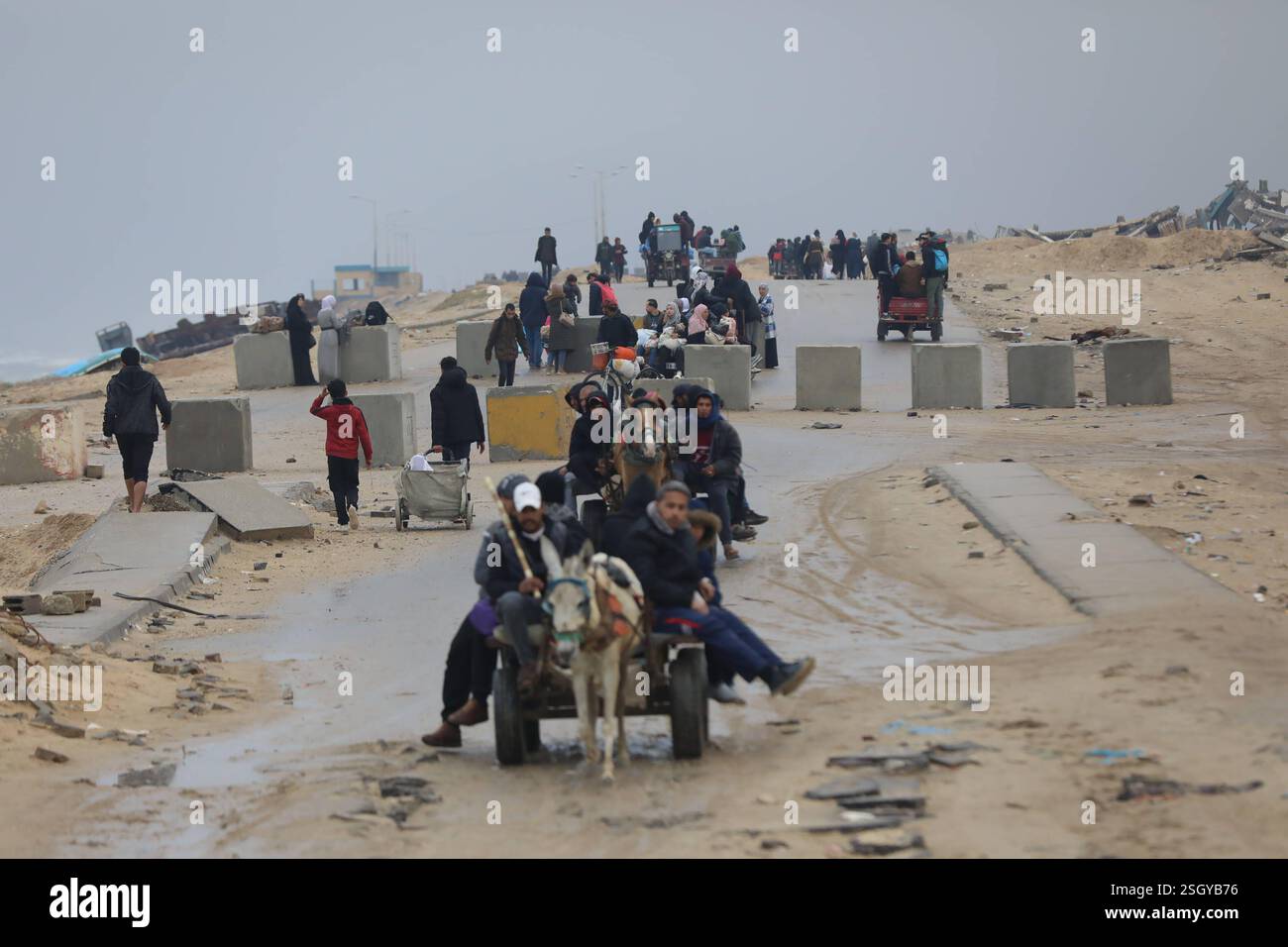 People walk along al-Rashid street between Gaza City and Nuseirat in ...