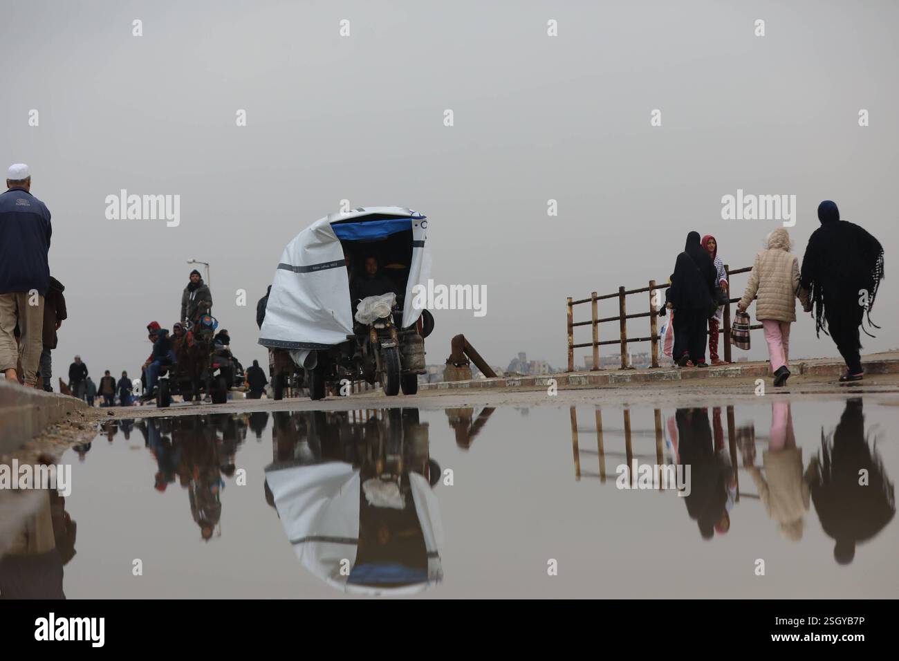 People walk along al-Rashid street between Gaza City and Nuseirat in ...