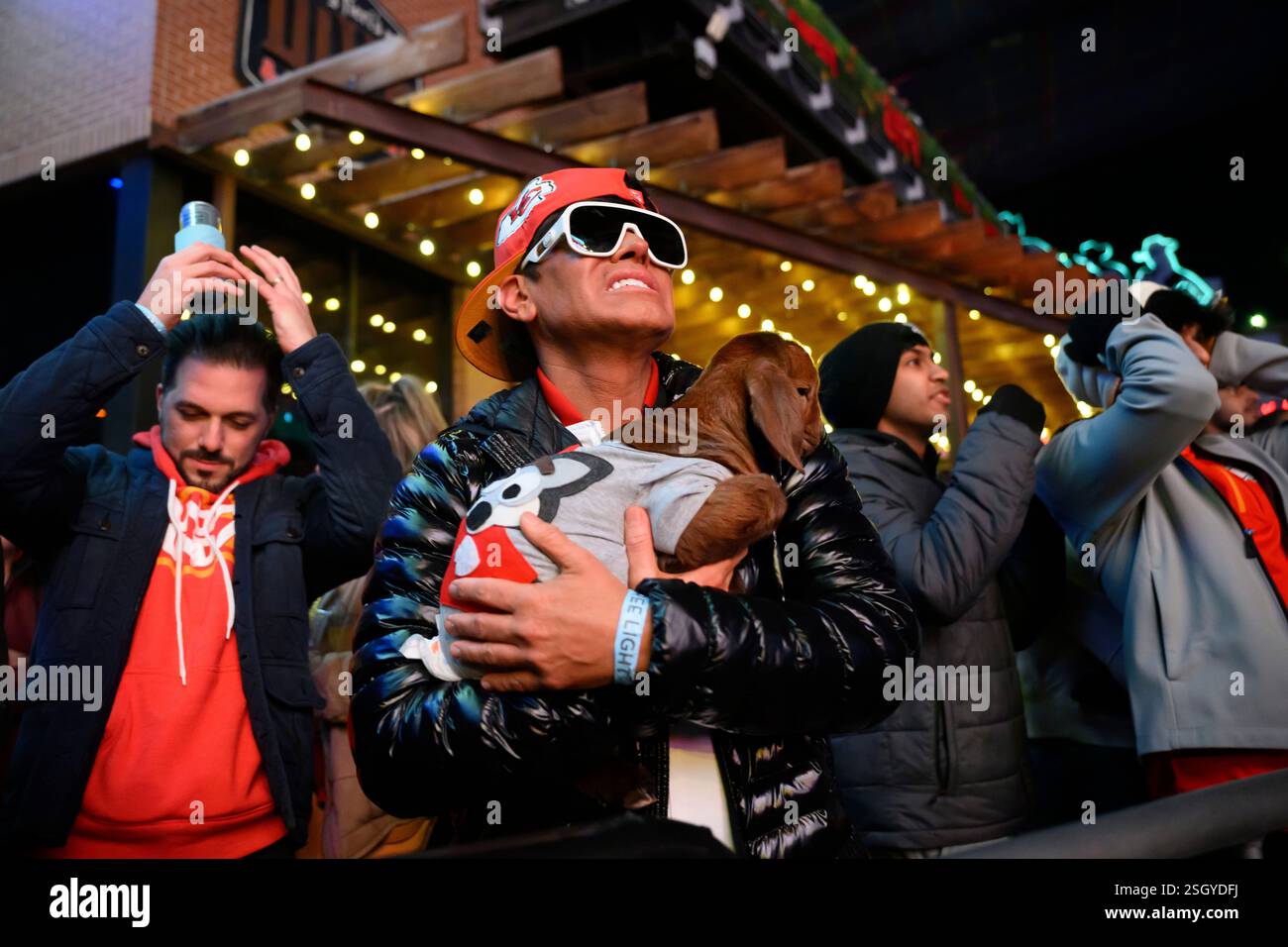 Holding a one-month old goat he brought with him, Ryan Wesley of Kansas ...