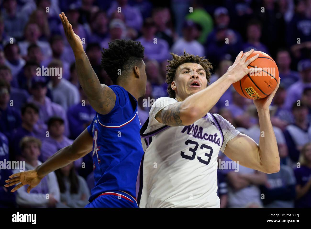 Kansas State guard Coleman Hawkins (33) pulls down a rebound in front ...