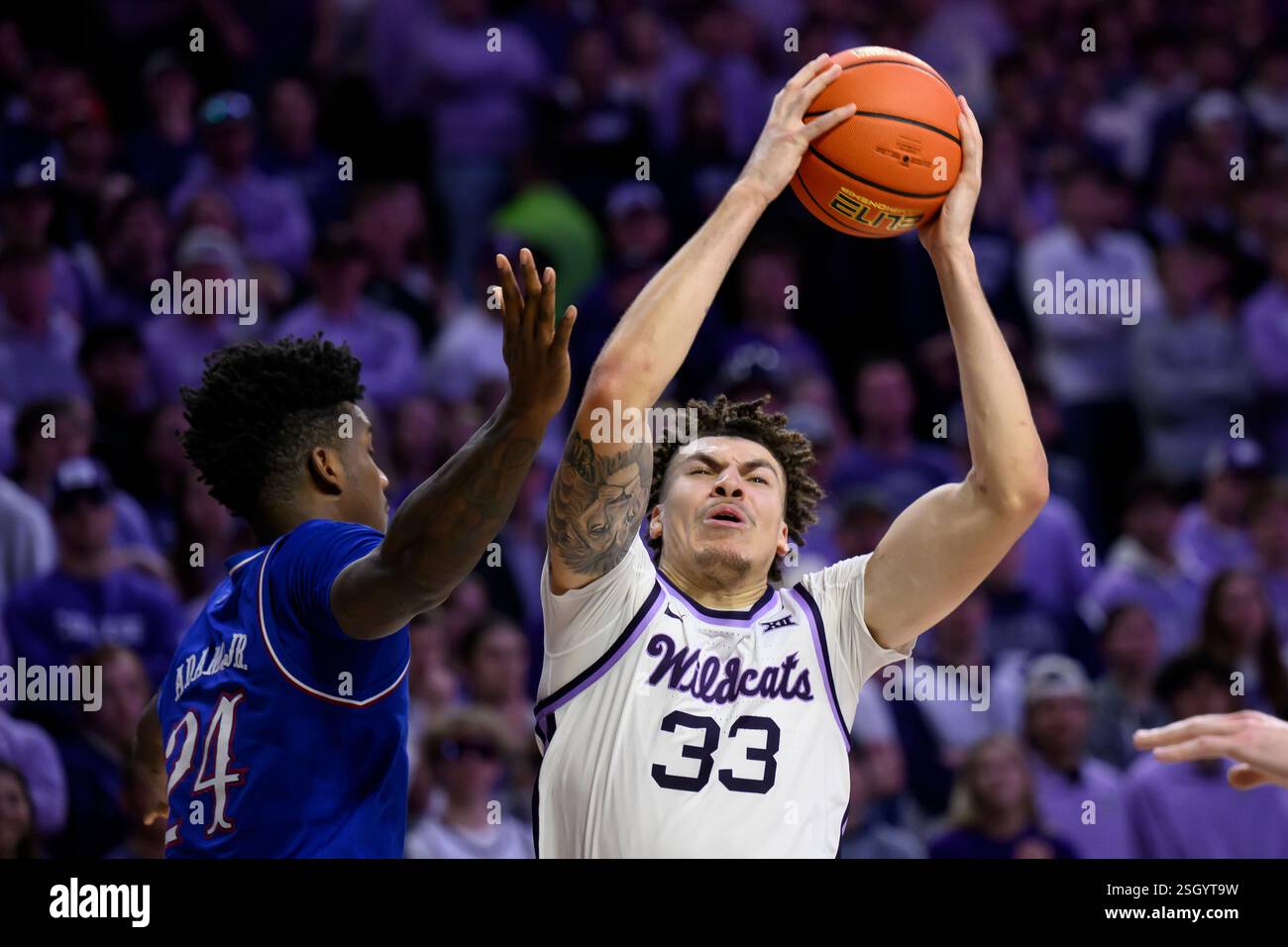 Kansas State guard Coleman Hawkins (33) pulls down a rebound in front ...