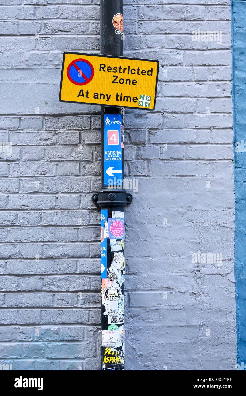 London, UK. Restricted Zone sign and National Cycle Netowrk sign on a ...