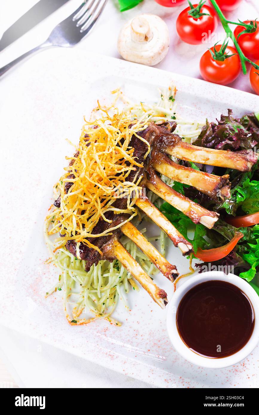 Delicious rack of lamb served over fresh greens with crispy toppings ...