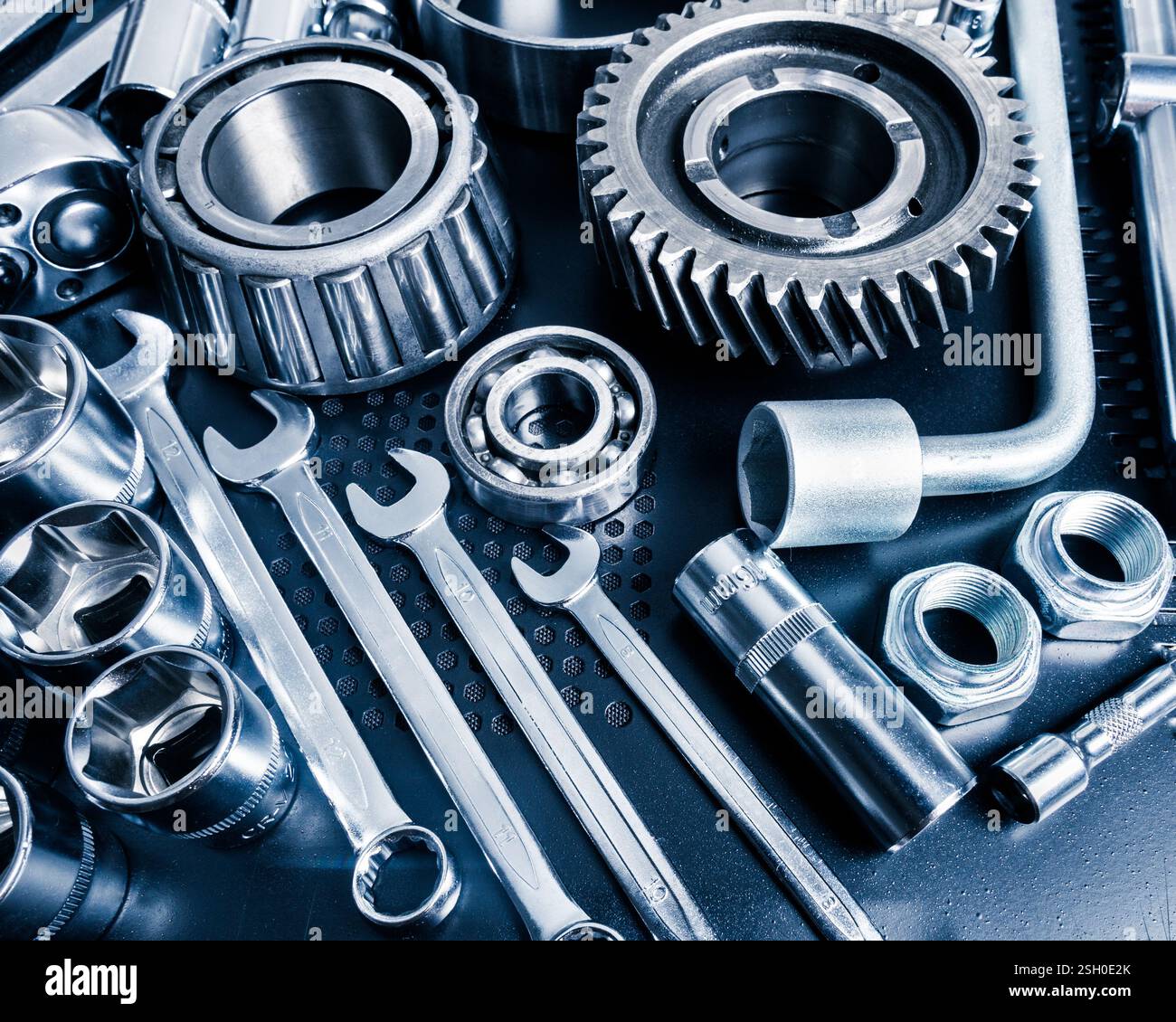 Collection of various metallic tools and components displayed on a ...