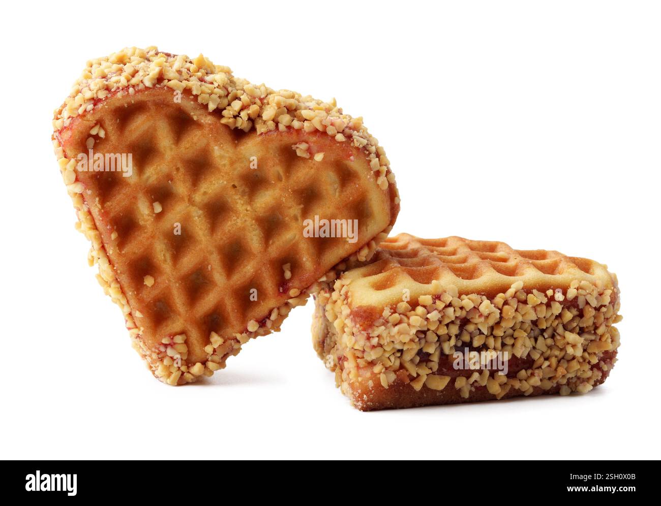 Heart-shaped waffle covered in crushed nuts served on a white ...