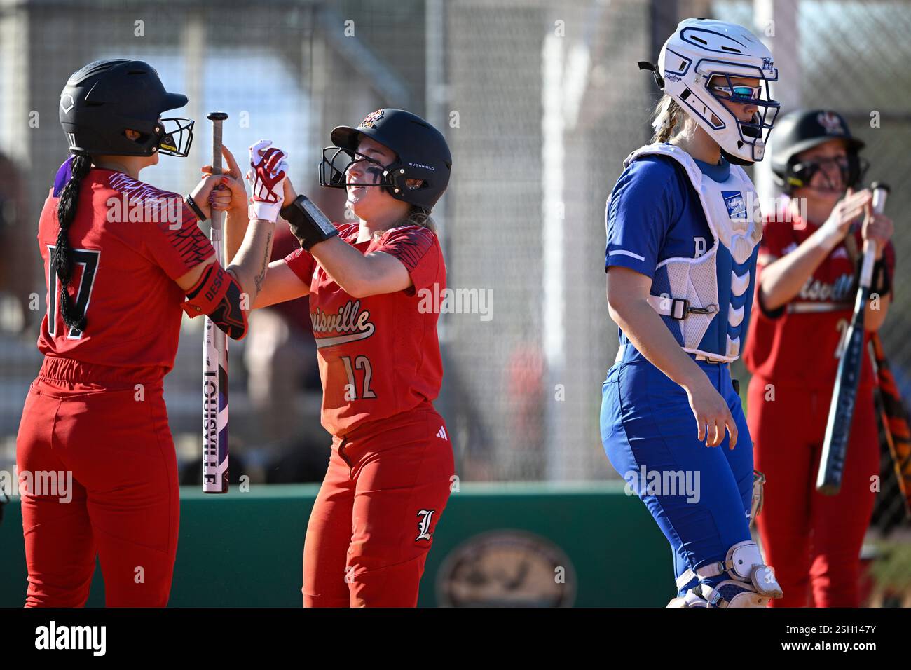Louisville's Easton Lotus (12) is congratulated by Bri Despines (17 ...