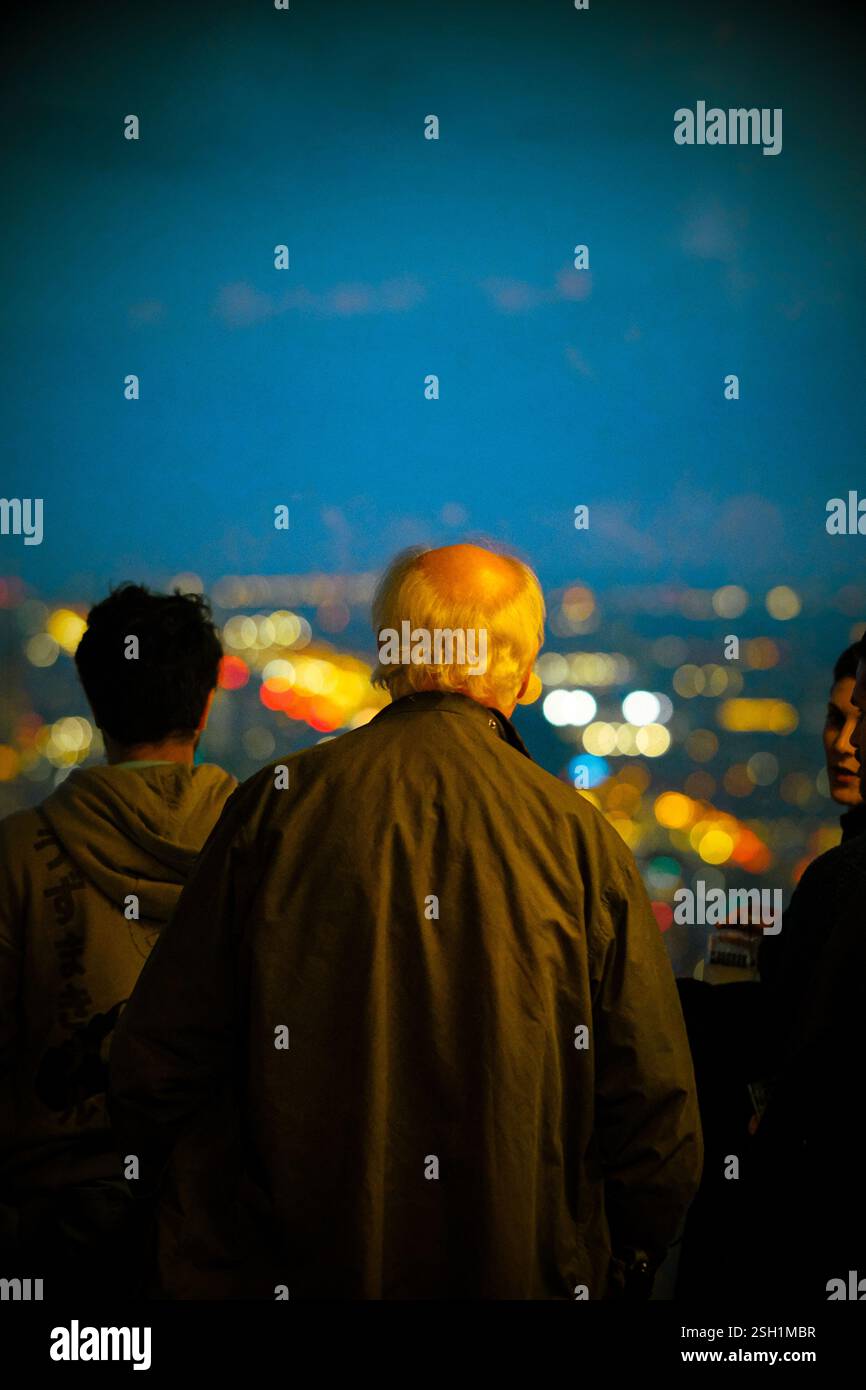 Man Overlooking City Lights at Night Urban Skyline View Stock Photo - Alamy