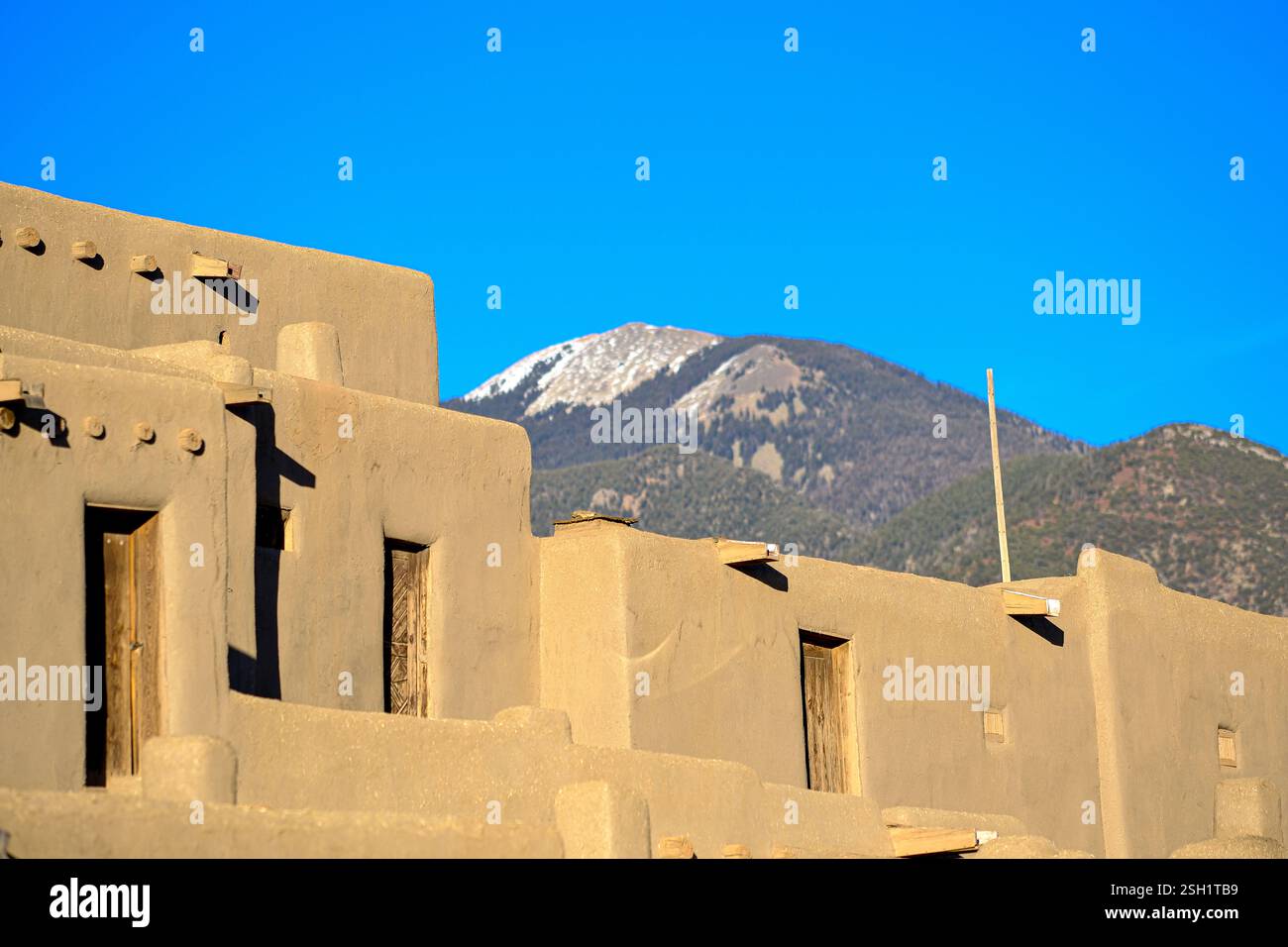 Charming Adobe Building with Snow-Capped Mountain Backdrop Stock Photo ...