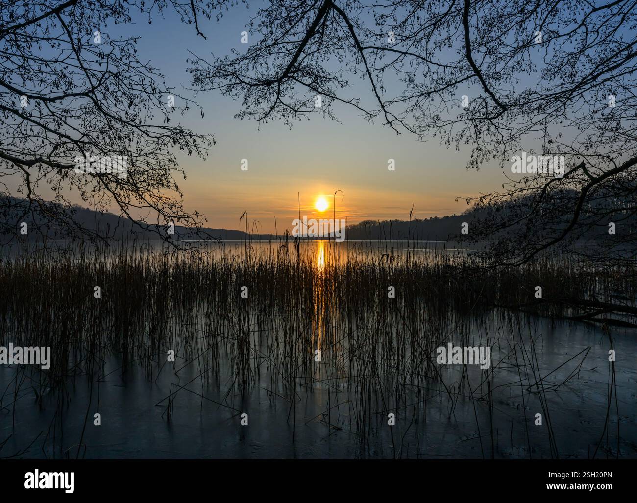 Heinersdorf, Germany. 10th Feb, 2025. The sunset shines over Lake ...