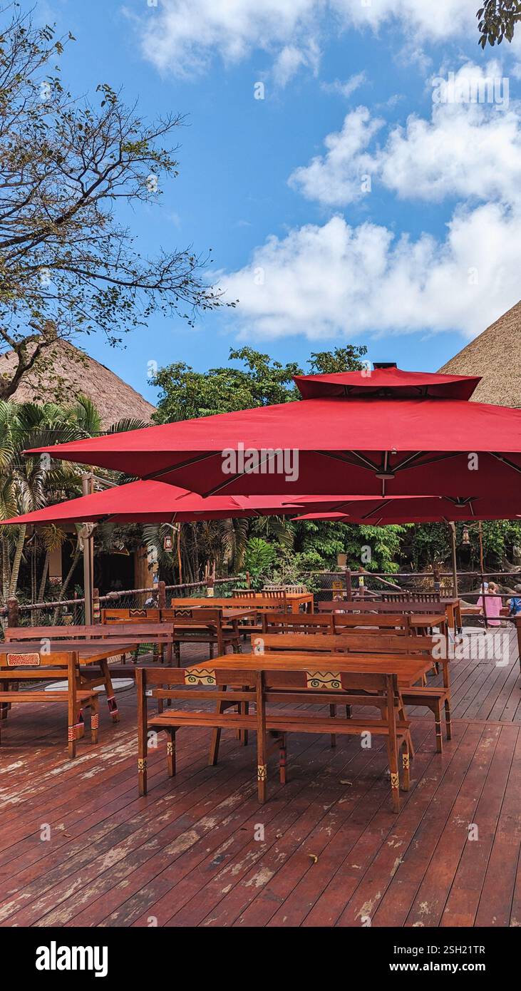 Outdoor Seating Area with Wooden Tables and Red Umbrellas Stock Photo ... Outdoor Seating Area with Wooden Tables and Red Umbrellas Stock Photo ...