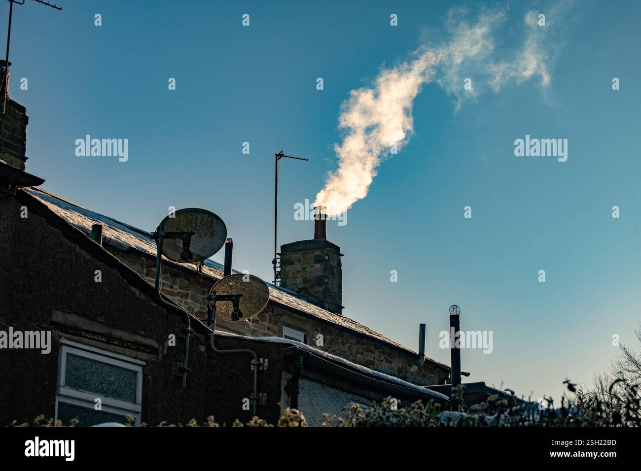Wood smoke from a wood burning stove coming out of a chimney ...