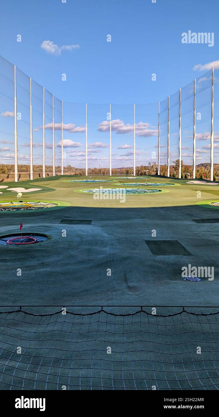 Modern Golf Driving Range with Tall Protective Nets Under a Blue Sky ...