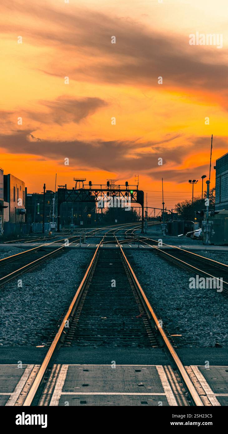 The photo captures a dramatic sunset over a railway crossing hi-res stock photography and images ...