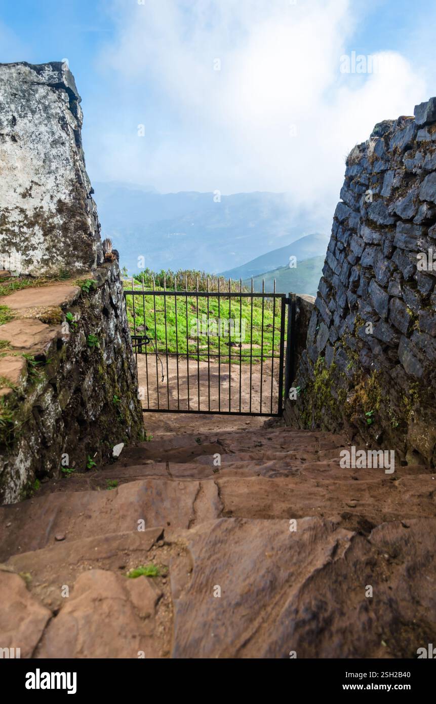 Stone fence with a iron gate on Mullayanagiri Peak in Chikkamagaluru ...