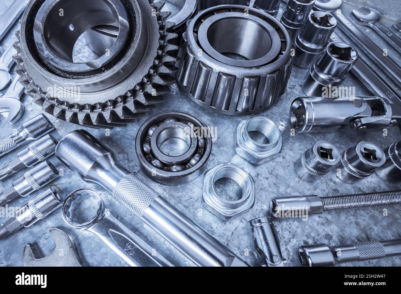 Collection of assorted mechanical tools and equipment arranged on a ...