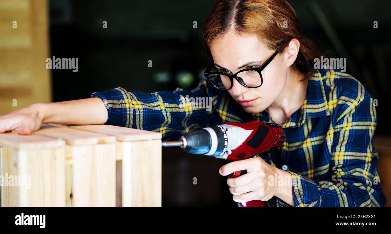 Female handy person repairing crate using screwdriver Stock Photo - Alamy