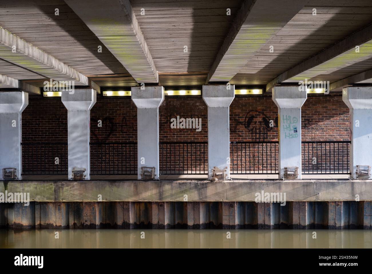 Shapes and shadows of the pillars under a city bridge in England ...