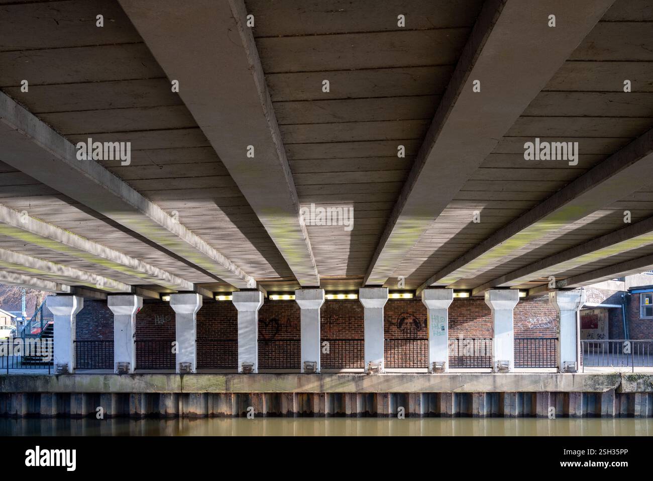 Shapes and shadows of the pillars under a city bridge in England ...