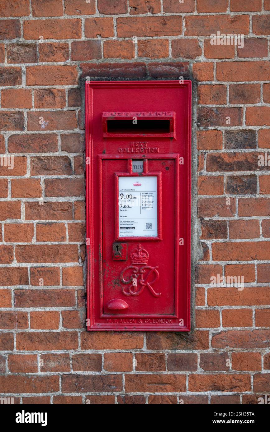 Traditional British post box in a brick wall. This one is marked GR ...