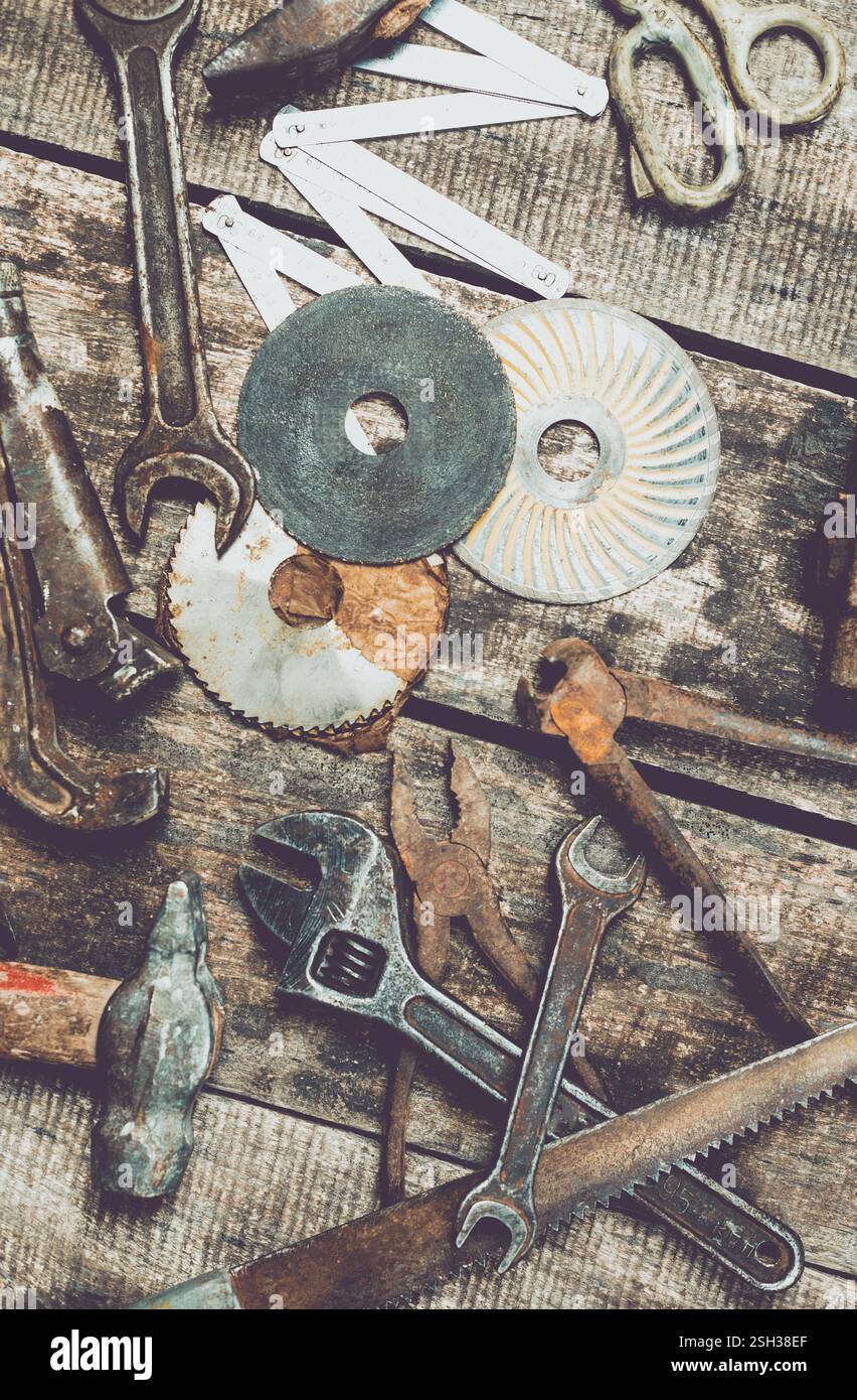 Collection of vintage hand tools and materials arranged on a rustic ...