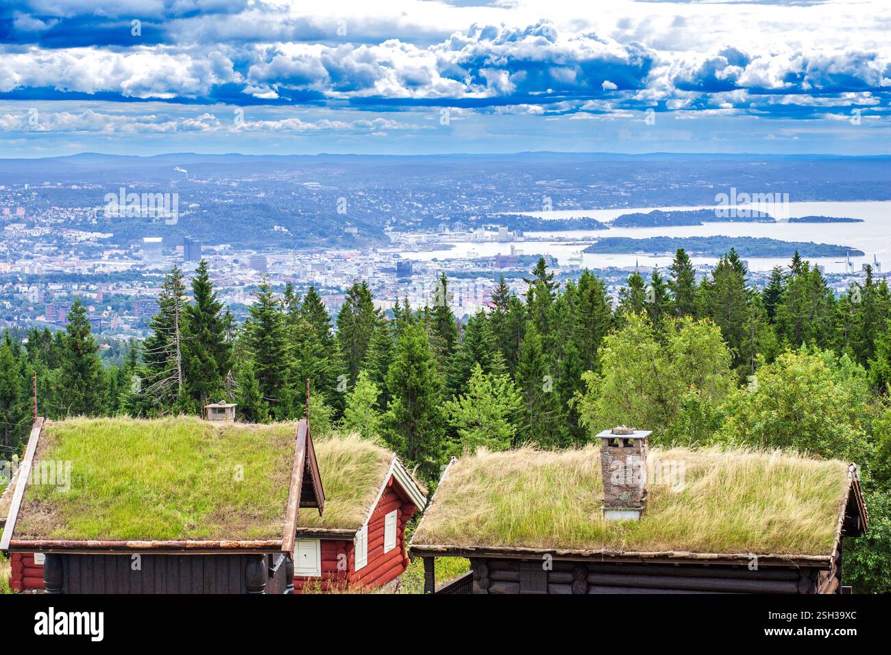 Wooden structures with grass roofs overlook the Oslo fjord, framed by ...