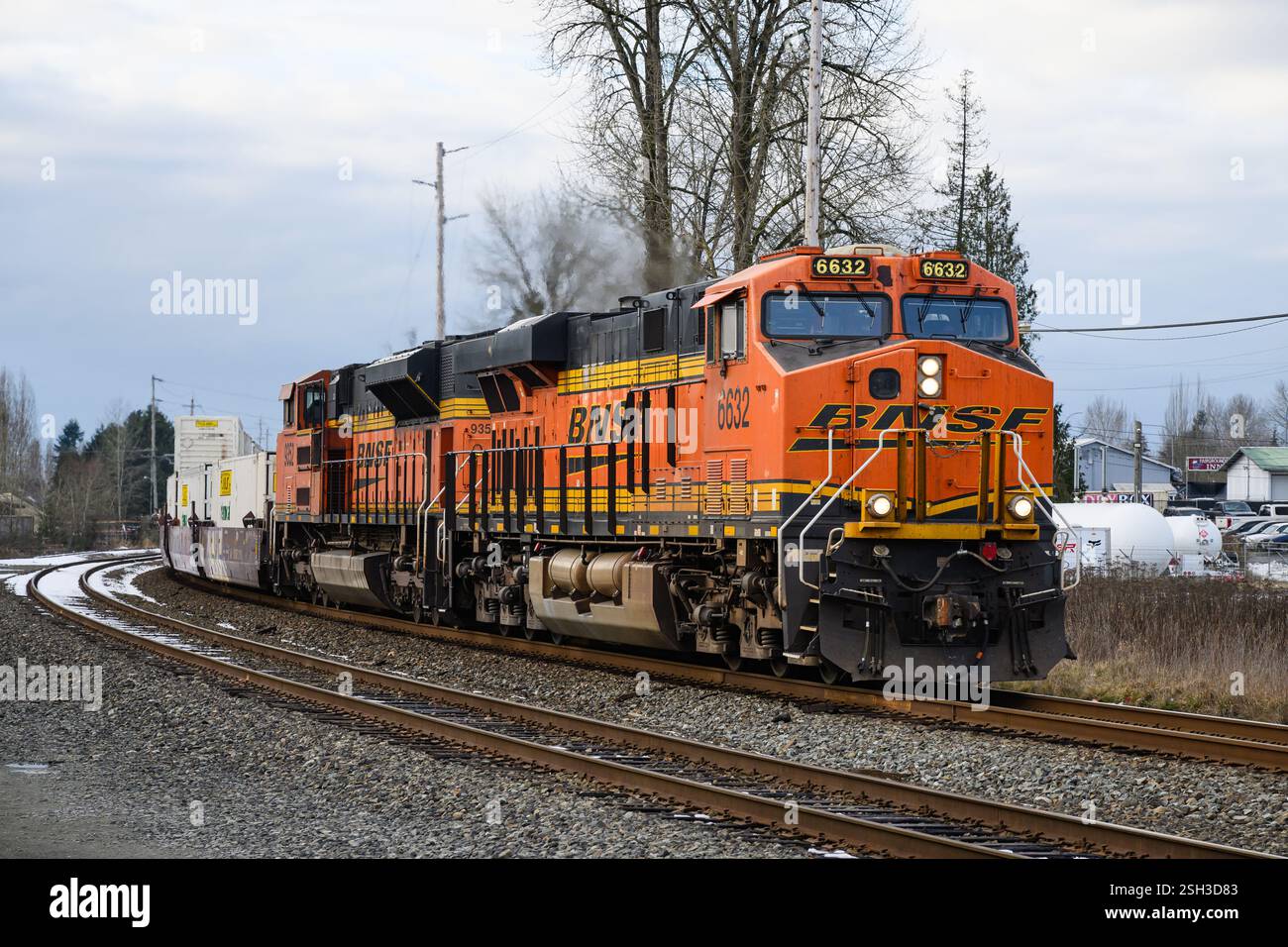 Monroe, WA, USA - February 7, 2025; BNSF intermodal freight train in winter on curved track ...
