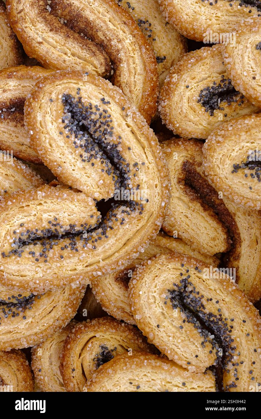 A variety of puff pastry cookies with sugar and poppy seeds, close up ...