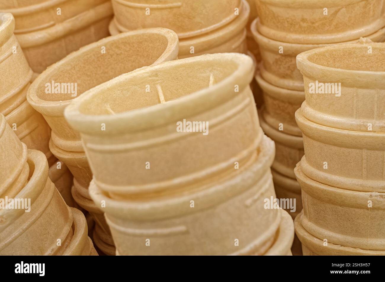 Lots of stacked empty ice cream cones, close up shot, abstract food ...