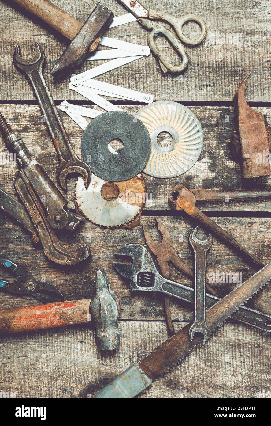 Vintage hand tools arranged on a rustic wooden workbench showcasing ...