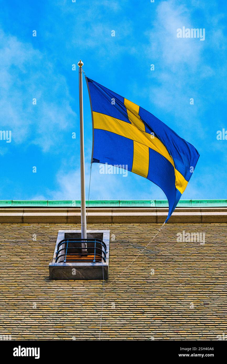 A bright blue sky provides a backdrop as the Swedish flag flies atop a ...