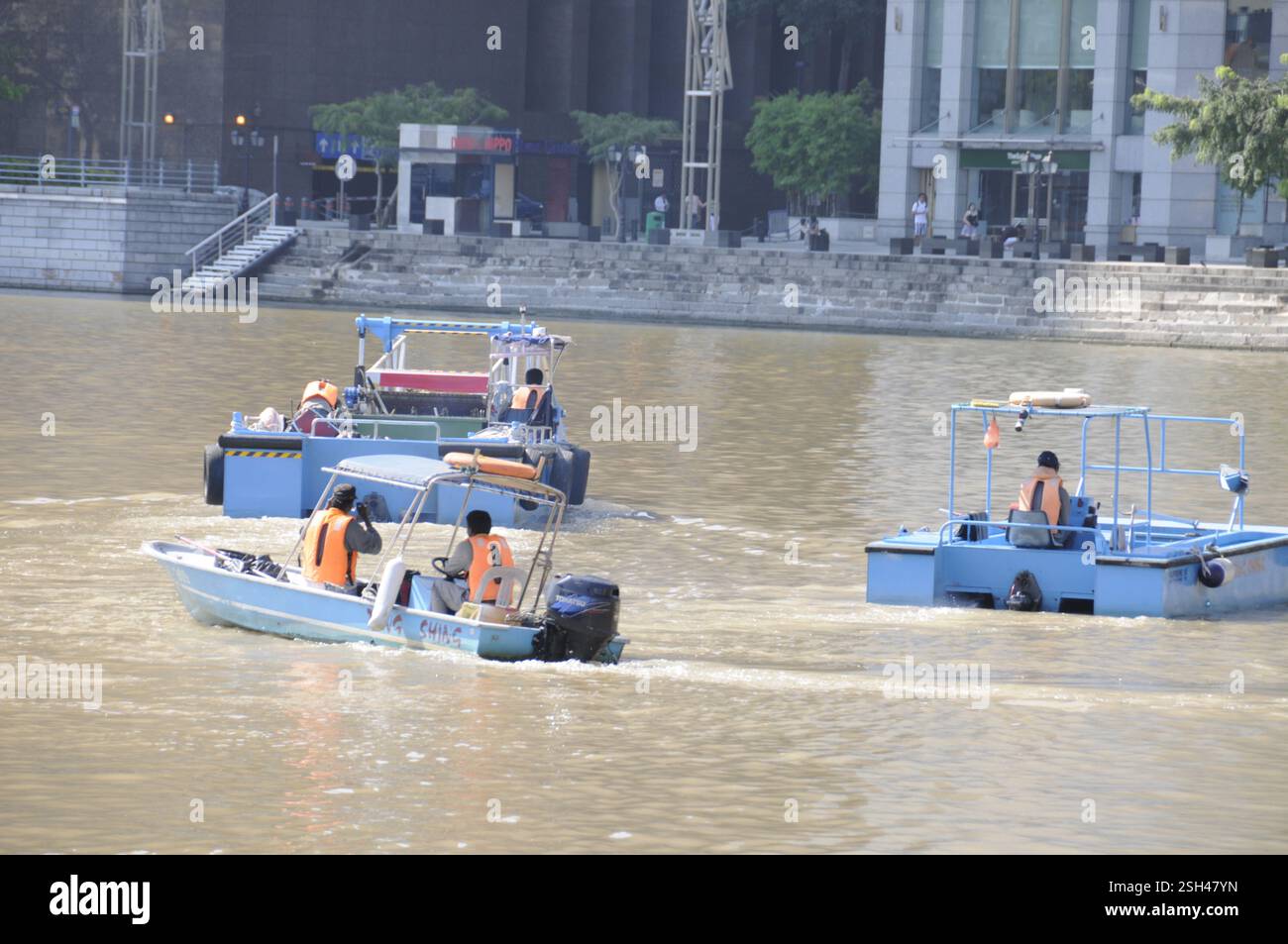 The Singapore Environment Agency, dredging the river bed of the ...
