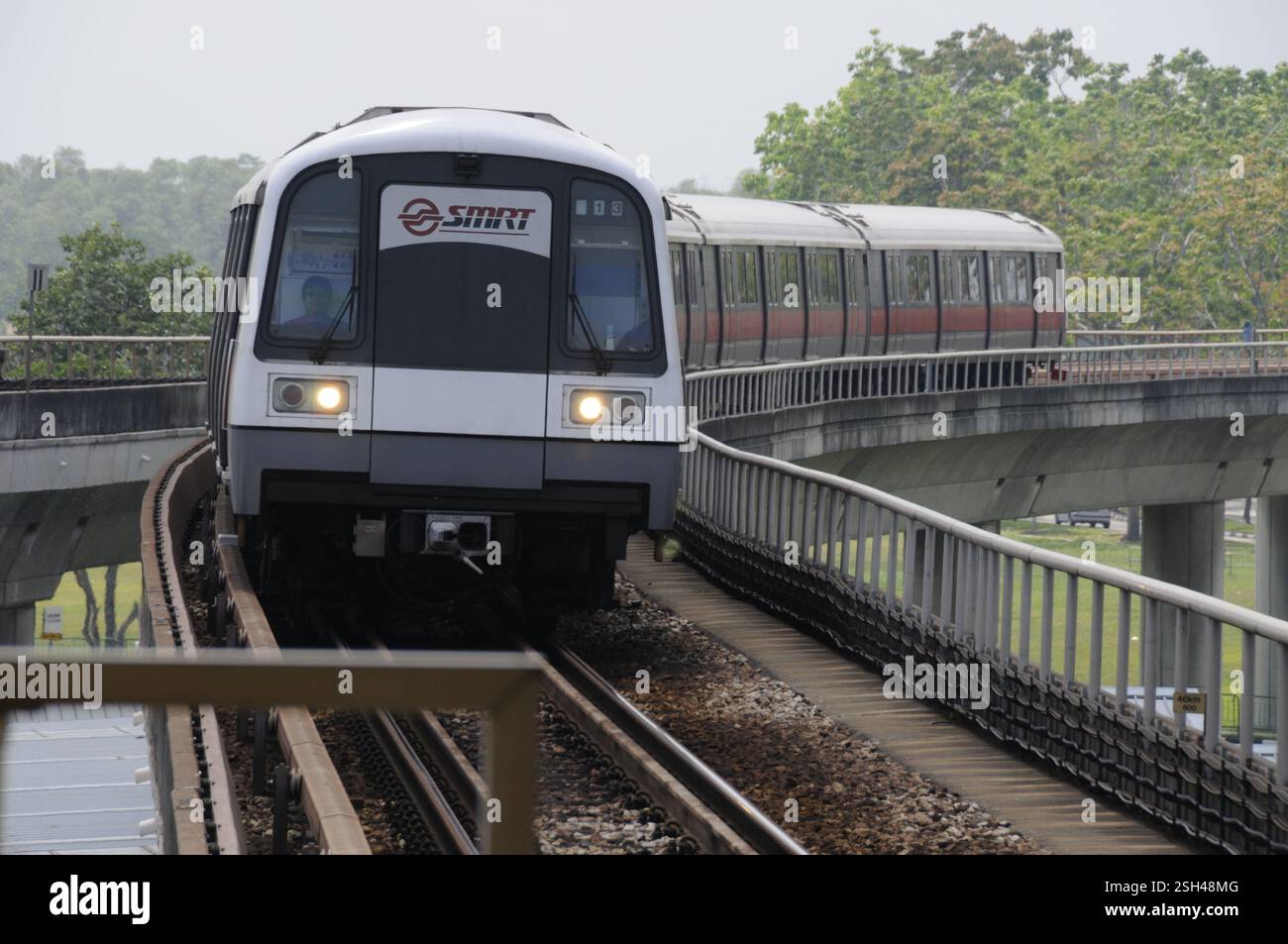An MRT (Mass Rapid Transit) train approaching one of the above ground ...