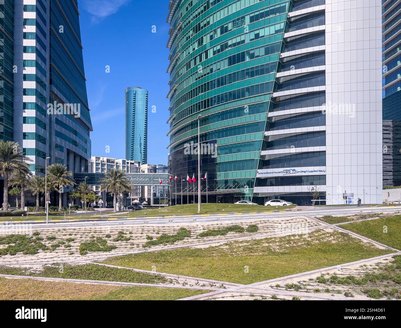 Manama, Bahrain - January 5, 2025: Modern skyscrapers and lush greenery ...